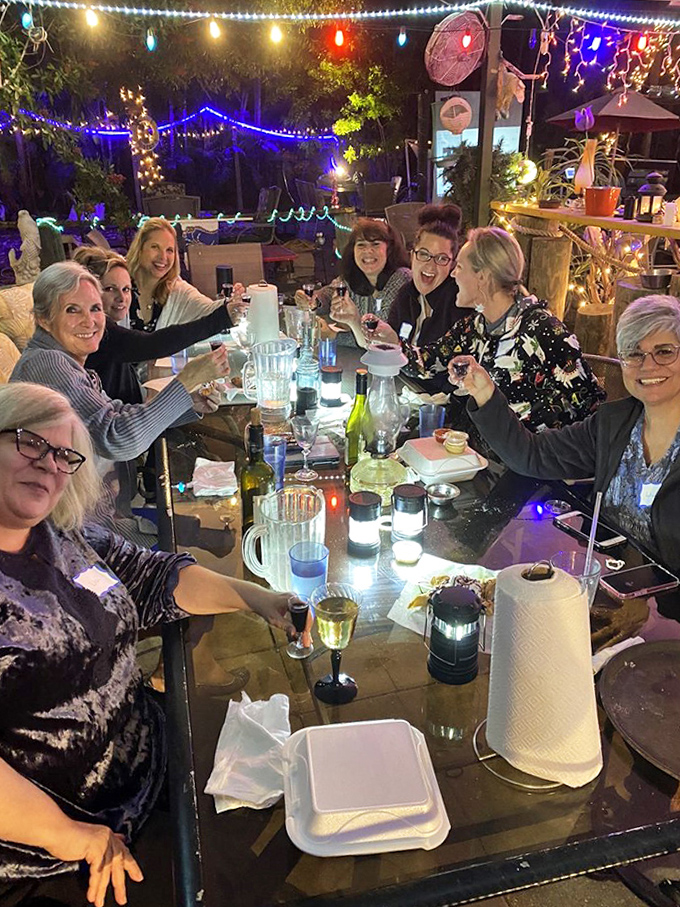 Happy diners enjoying the outdoor evening ambiance under twinkling lights &ndash; the perfect Florida dining experience.