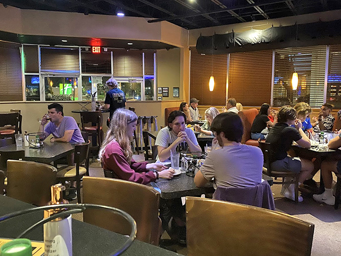 Diners enjoying that magical moment when conversation pauses because the food demands complete attention&mdash;the universal language of deliciousness.