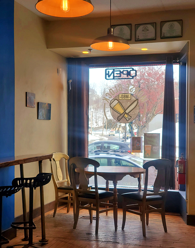 Sunlight streams through large windows, illuminating a corner table that's perfect for savoring your meal while watching Barre's Main Street bustle by.