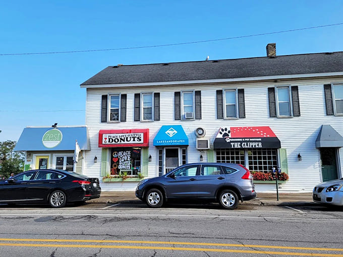 The shop's charming exterior fits perfectly into this Traverse City streetscape, its bright red awning a beacon for donut enthusiasts.