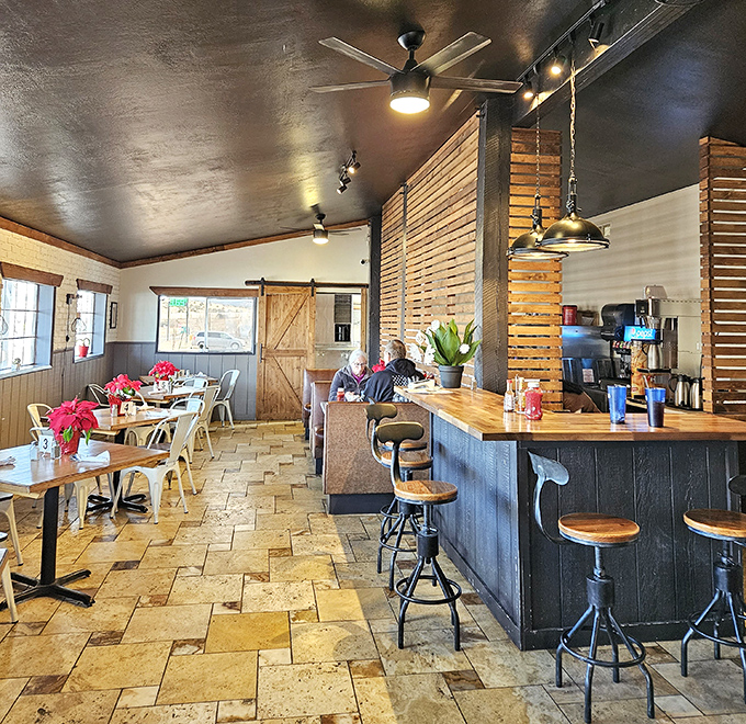 Thoughtful design touches like wooden pallet dividers and pendant lighting create distinct dining zones while maintaining the restaurant's cohesive, rustic charm.