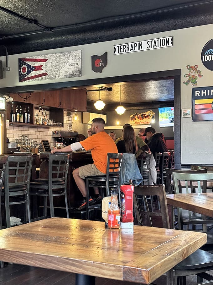Ohio pride shines through the d&eacute;cor &ndash; Terrapin Station sign, state flag, and sports memorabilia create a sense of place without trying too hard.