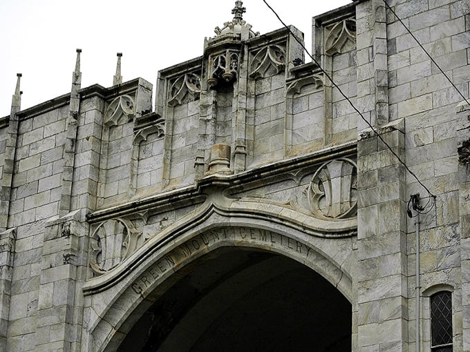 Intricate Gothic stonework frames the cemetery entrance, showcasing the craftsmanship that Vermont's master stonecutters were famous for worldwide.