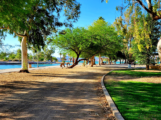 Shaded pathways invite leisurely strolls along the waterfront, where desert heat meets cooling lake breezes.