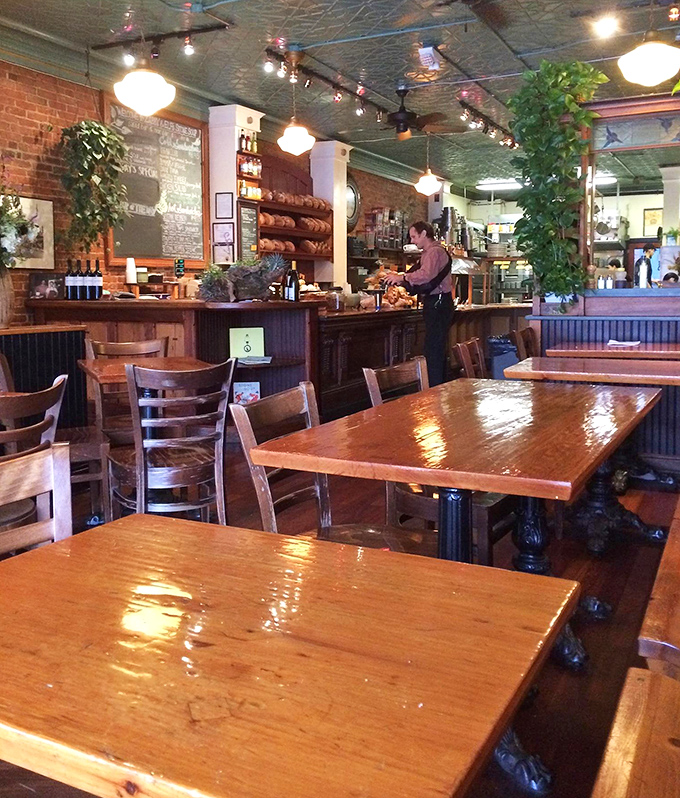 Polished wooden tables await the lunchtime rush, each surface telling stories of countless meals shared among friends and strangers alike.
