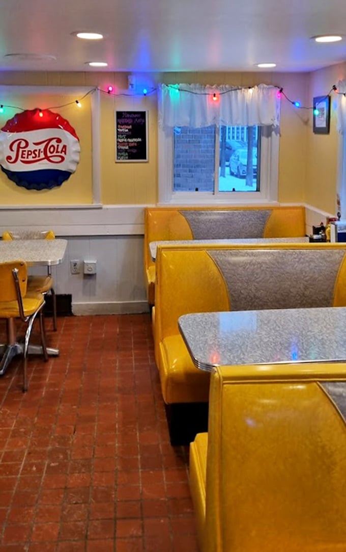 Colorful string lights and vintage Pepsi-Cola signs add character to the cozy dining room. Those yellow booths have cradled countless conversations over coffee.