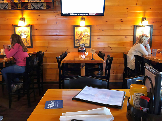 Wood-paneled walls and thoughtful lighting create an intimate atmosphere where conversations flow as easily as the drinks.
