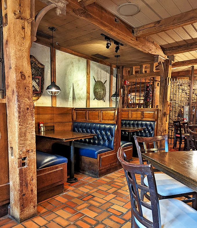 Navy blue booth seating against exposed brick walls creates the perfect backdrop for both romantic dinners and friendly gatherings.