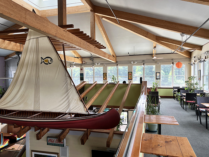 Whimsy meets craftsmanship in the upper dining area, where an actual canoe hangs from wooden beams &ndash; a playful nod to Vermont's outdoor heritage.