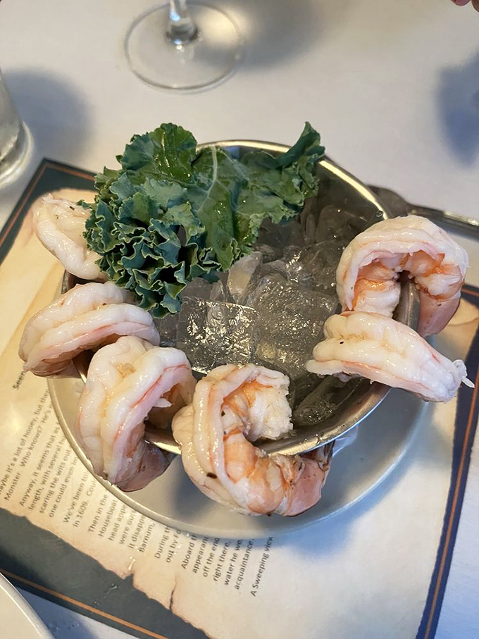 Jumbo shrimp perched elegantly around a cocktail glass, their plump curves promising sweet, tender bites that need only a dip in zesty sauce for perfection.