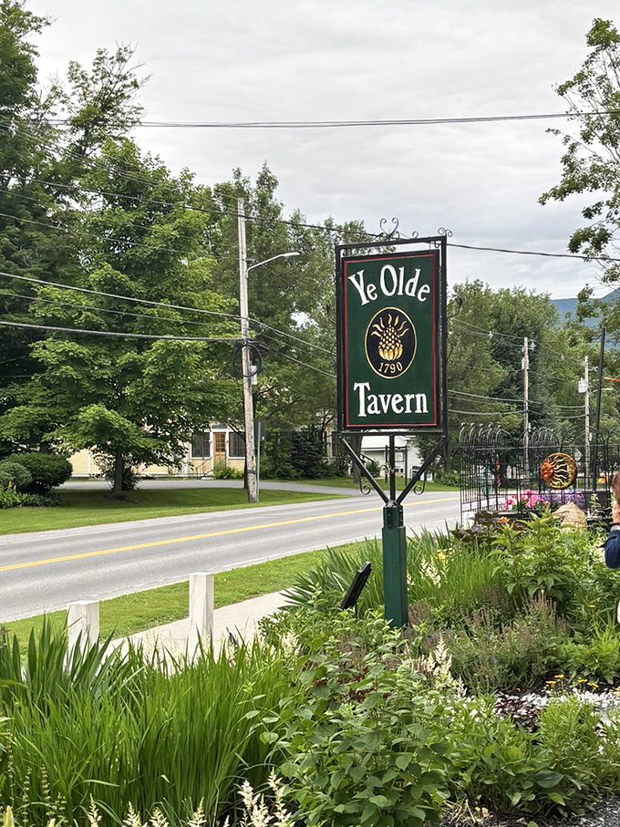 The iconic green sign stands sentinel by the roadside, marking the spot where culinary history and modern appetites meet deliciously.
