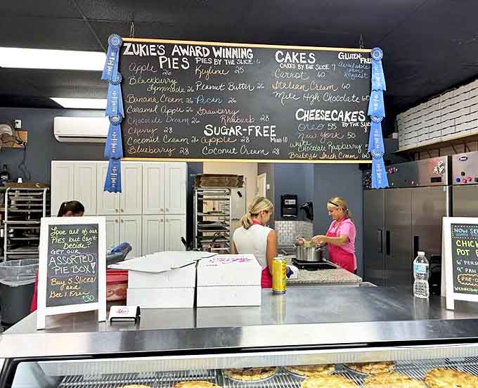Behind the counter, the bakery team works their magic, surrounded by blue ribbons that testify to their award-winning creations.