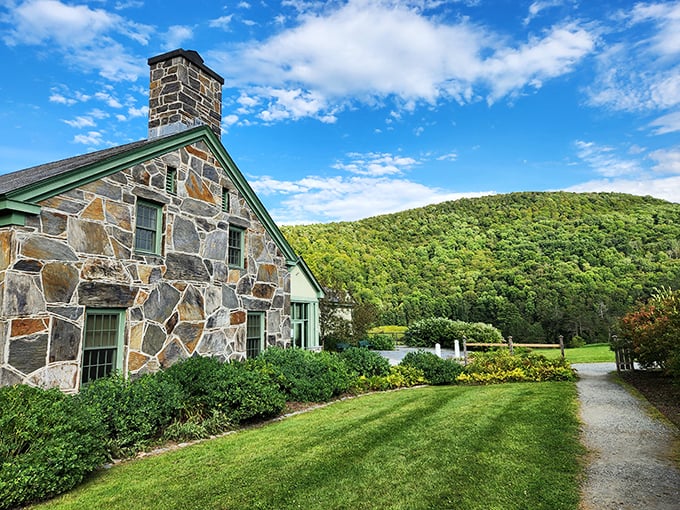 This sturdy stone house stands defiant against time and elements, its rugged exterior hiding cozy rooms that have sheltered generations.