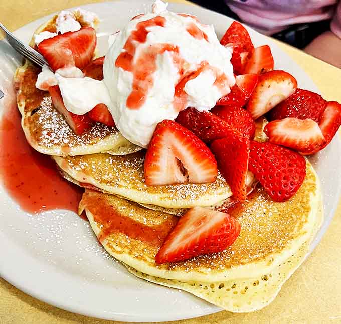 Strawberry pancakes that look like they just stepped out of a food magazine &ndash; fresh berries and cream creating edible artwork.