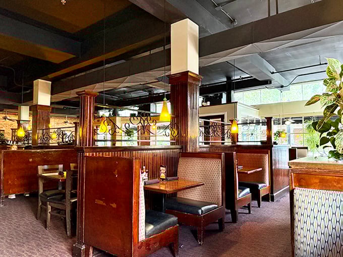 Cozy booths and warm wood tones create intimate dining spaces where conversations flow as easily as the cocktails.