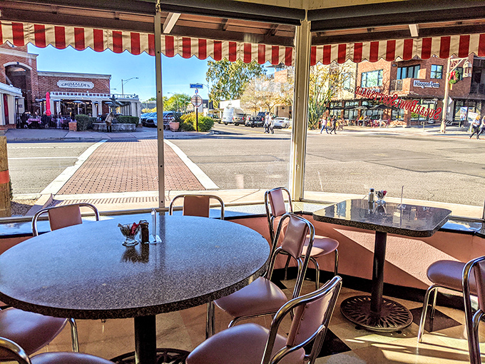 Sun streams through large windows, illuminating the classic diner setting and offering views of Old Town Scottsdale's charming streetscape.