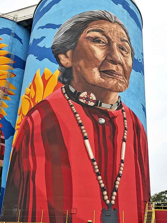 Indigenous heritage honored in brushstrokes, with traditional jewelry and clothing meticulously rendered against the blue sky background.