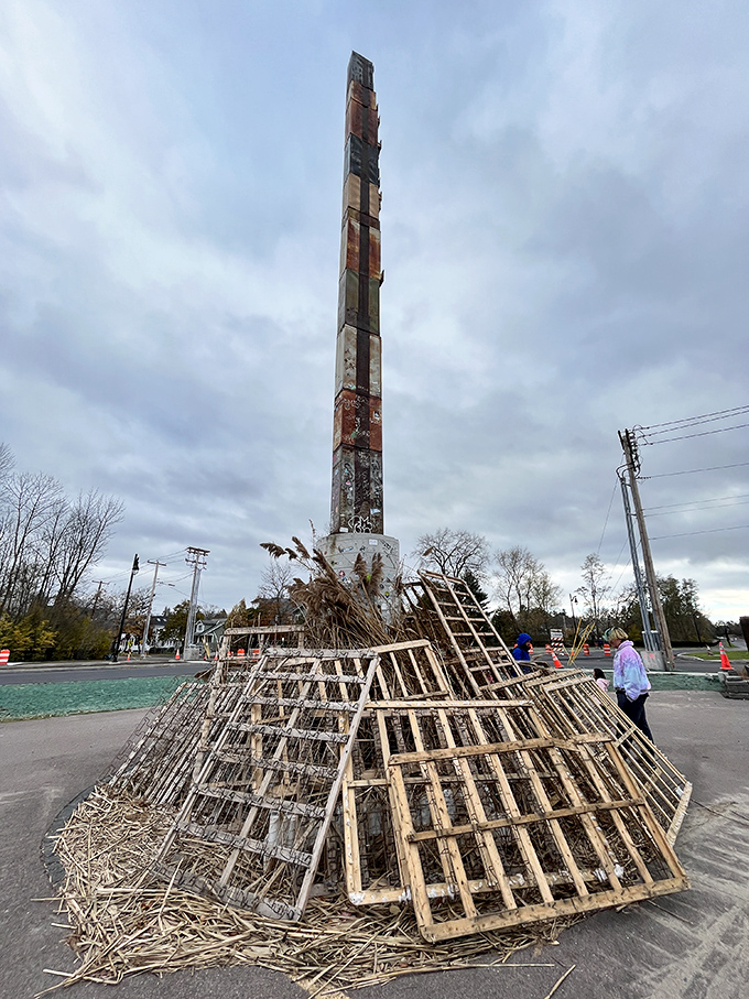 Wooden pallets surround the base like offerings to the office supply gods, adding another layer of delightful absurdity.