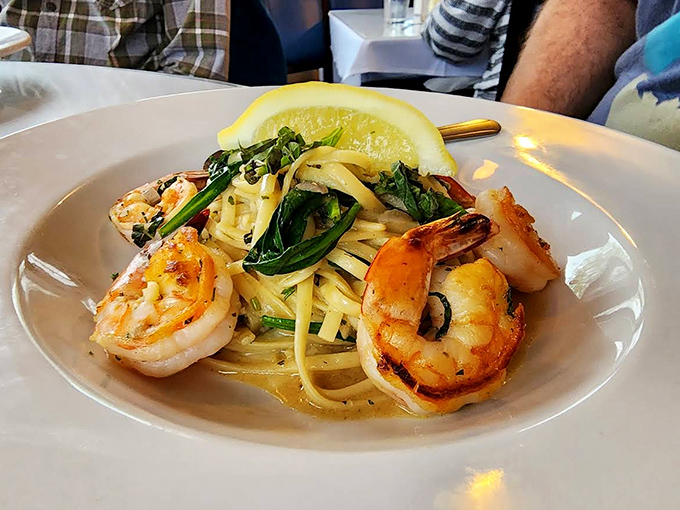 Plump shrimp nestled among pasta strands &ndash; a symphony of garlic, butter and herbs that makes you want to applaud.