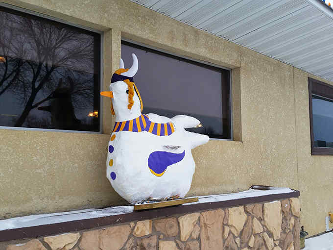 A whimsical snow chicken sporting Minnesota Vikings colors guards the entrance, changing outfits with the seasons like a local mascot.