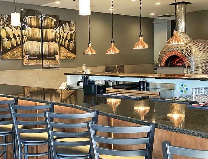Counter seating by the wood-fired oven offers front-row seats to pizza-making magic and the warmth of real flames.
