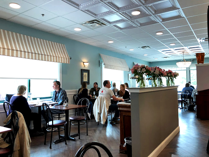 Soft blue walls, elegant lighting, and comfortable seating create the kind of space where breakfast could easily turn into lunch.