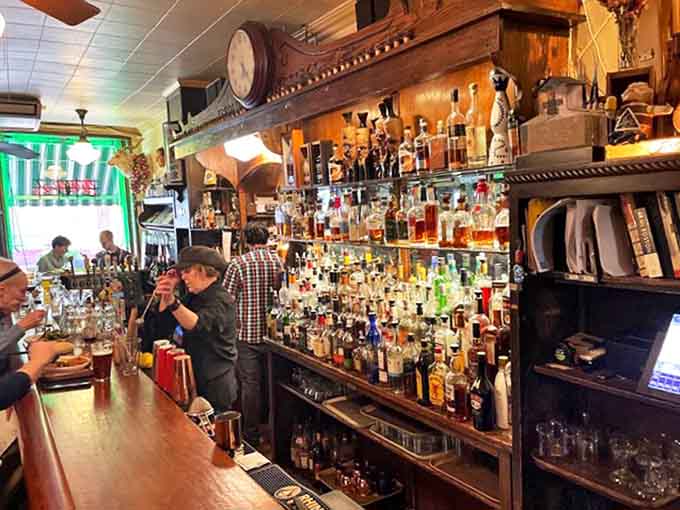 Behind the bar, bottles gleam like treasures &ndash; a carefully curated collection built over decades, each one waiting to become part of your evening's story.