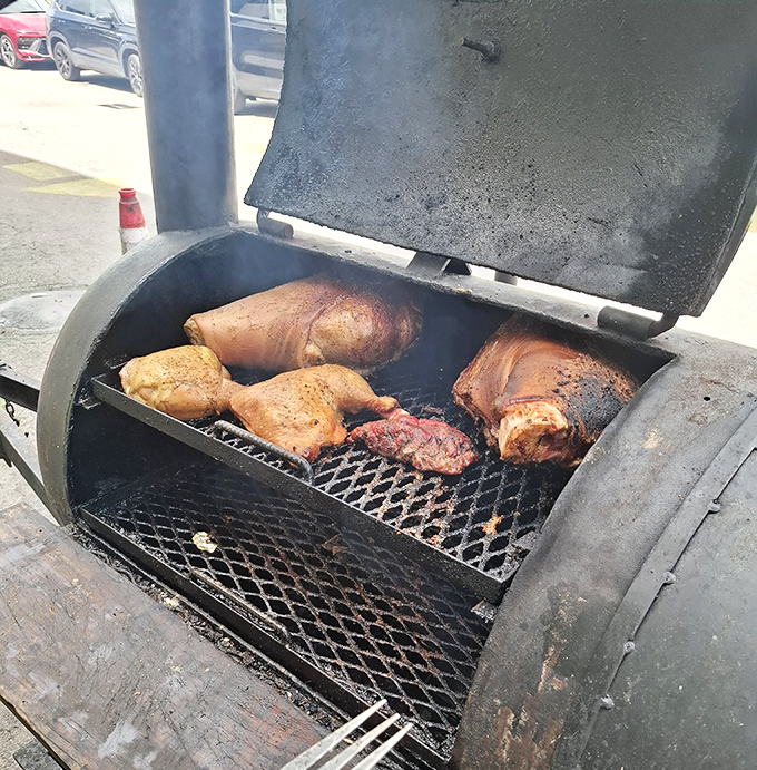 Smoke rises from outdoor grills where meat transforms into magic and diet plans go to die happy deaths.