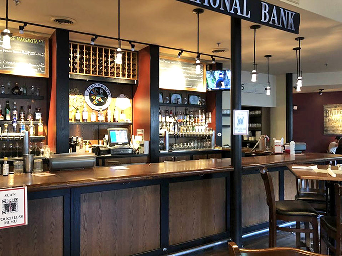 Rustic charm meets modern comfort at the bar, complete with tin ceiling details and inviting warm lighting.