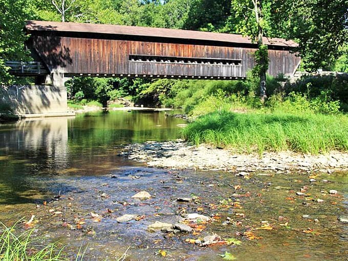 Benetka Road Covered Bridge whispers tales of yesteryear, its weathered timbers sheltering travelers just as they have for generations.