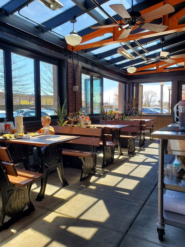 Sunlight streams through the windows of this inviting dining area, where sweet potato fry legends are born with every order.