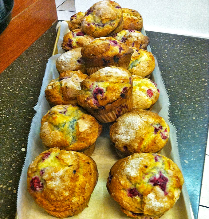 Fresh-baked muffins bursting with blueberries showcase the kind of from-scratch baking that makes the bakery part of the name meaningful.