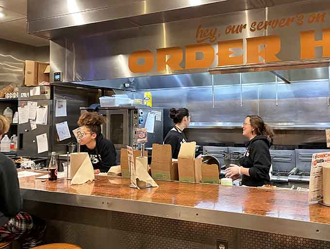 The kitchen crew works their magic behind the counter, orchestrating the perfect balance of efficiency and care that makes each order special.