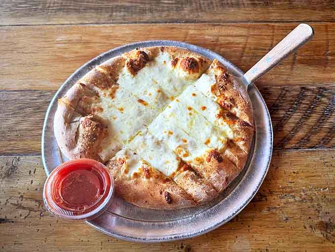 Golden breadsticks arrive hot from the oven, perfect for soaking up extra sauce or just eating by the handful.