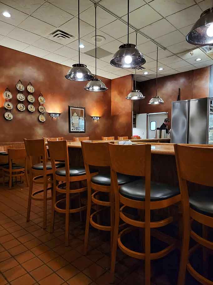 Another angle of the warm interior shows the open kitchen where pasta magic happens daily, no smoke and mirrors required.