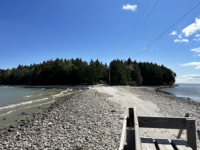 A rocky shoreline meets crystal waters, creating that perfect spot where skipping stones becomes an Olympic-worthy activity.