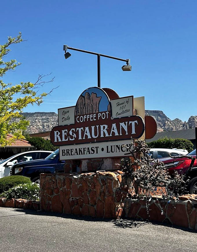 That vintage sign has welcomed hungry travelers for decades, promising breakfast and lunch with the red rocks as your backdrop.