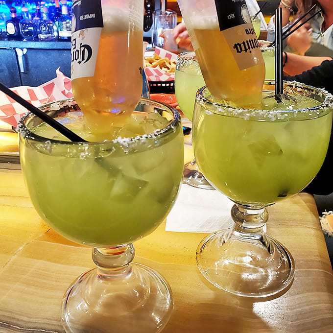 Coronita Extra Submerged in Margarita: The infamous "beer-a-rita" &ndash; where a Corona bottle dramatically dives headfirst into a margarita. Twice the fun in one glass!