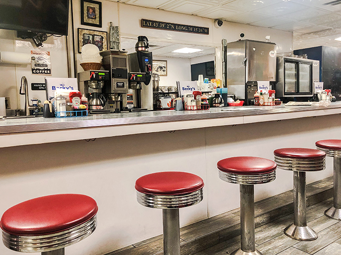 Counter culture: Those iconic red swivel stools invite you to settle in for coffee, conversation, and a front-row view of kitchen choreography.