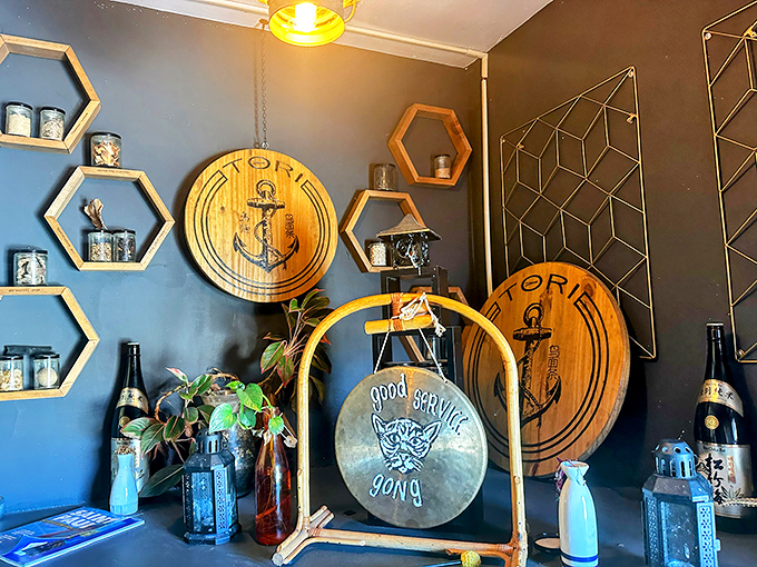 Hexagonal shelves and wooden Tori logos create a stylish backdrop that honors both Japanese design and nautical influences.