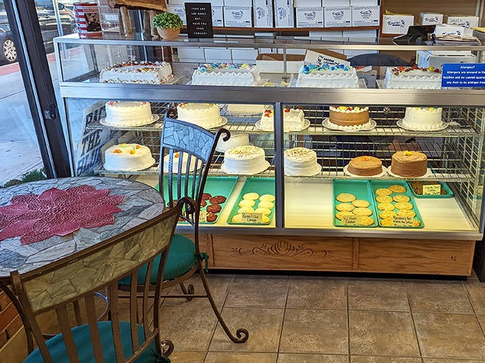 The dining area offers a moment of respite with its charming tables, while the cake display promises celebrations waiting to happen.