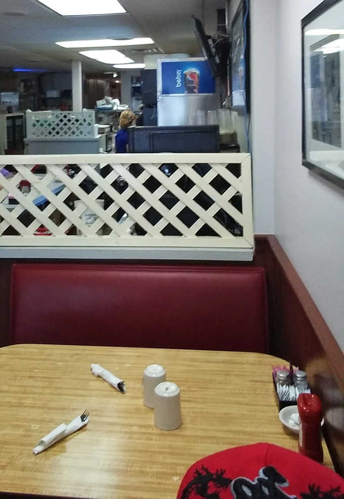 The dining area's lattice dividers and red vinyl booths create semi-private worlds for conversations that flow as freely as the coffee.