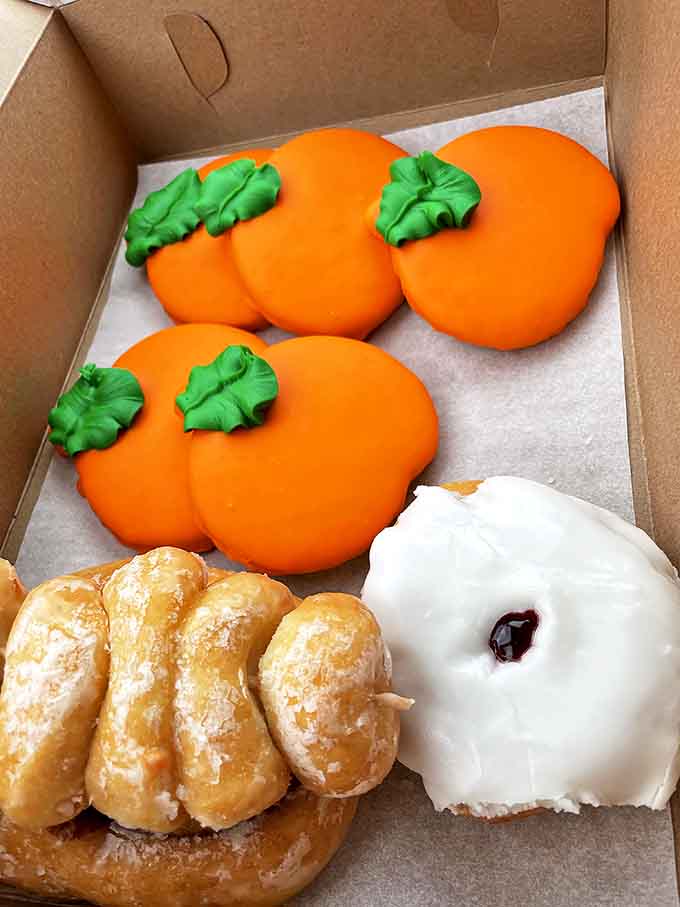Seasonal specialties like these pumpkin-shaped cookies and glazed treats show why locals mark their calendars for Schuler's holiday offerings.