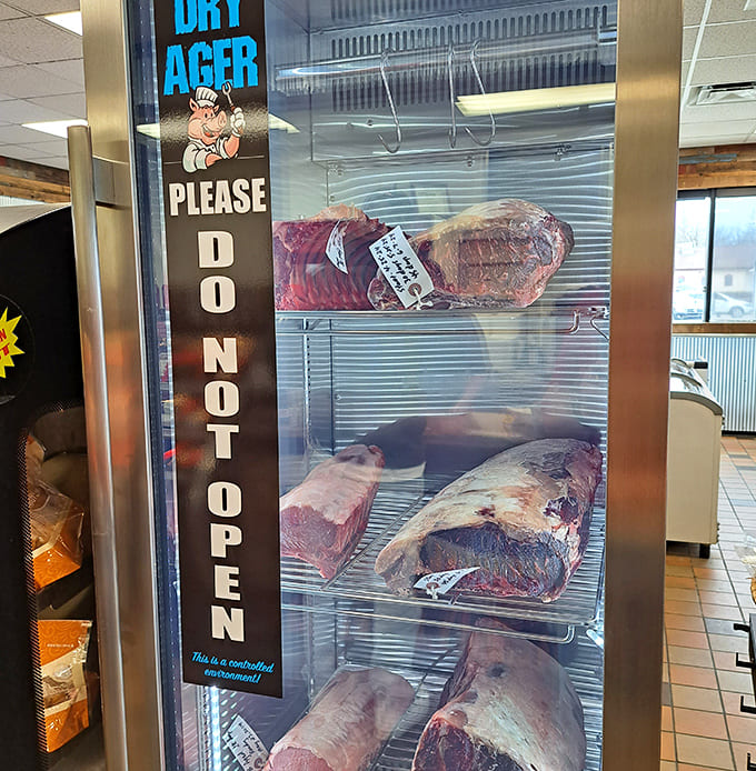 The dry-aging beef display that's basically a museum exhibit for carnivores, showcasing premium cuts behind glass.