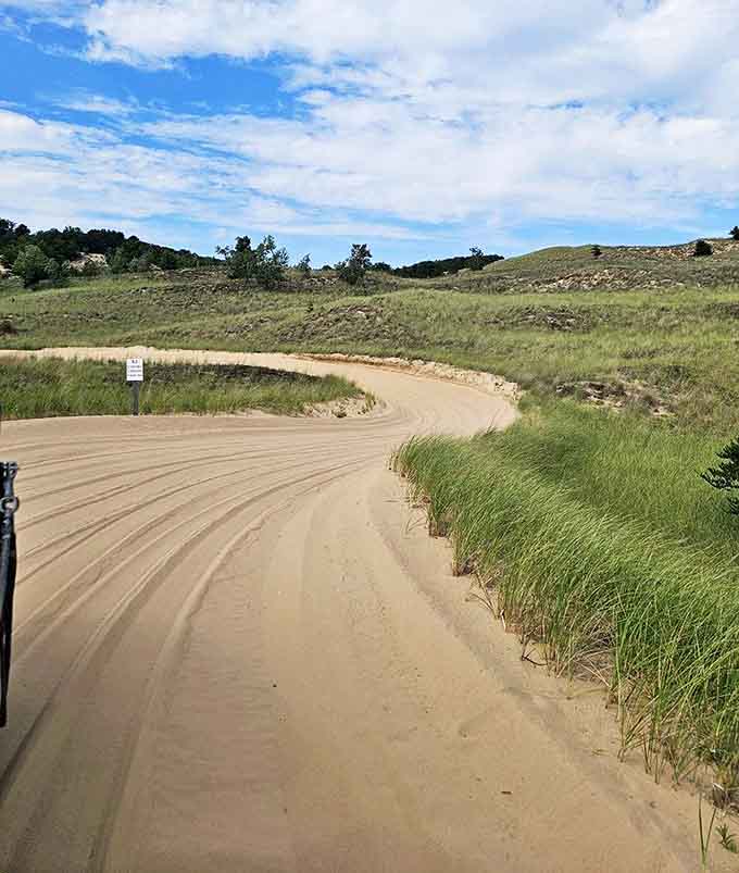The winding paths through the dunes create an ever-changing landscape where each turn reveals something new, from forest to sand to stunning lake views.