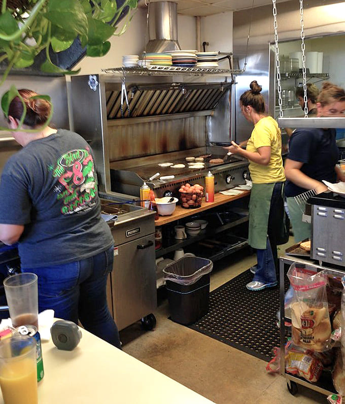 The open kitchen lets you watch the breakfast ballet unfold, with cooks orchestrating multiple orders on the griddle like conductors leading a delicious symphony.