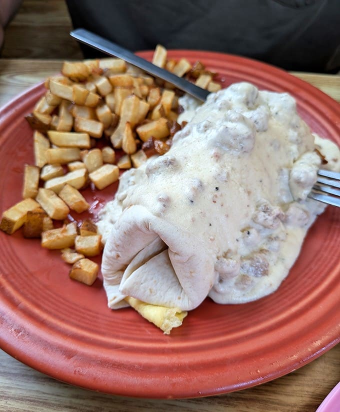 This breakfast burrito smothered in sausage gravy with crispy hash browns proves indulgence is sometimes absolutely necessary.