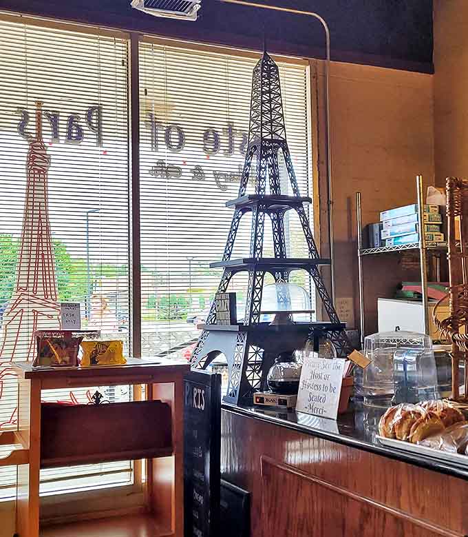 A miniature Eiffel Tower stands sentinel by the window, reminding guests they've found a genuine slice of France in suburban Illinois.