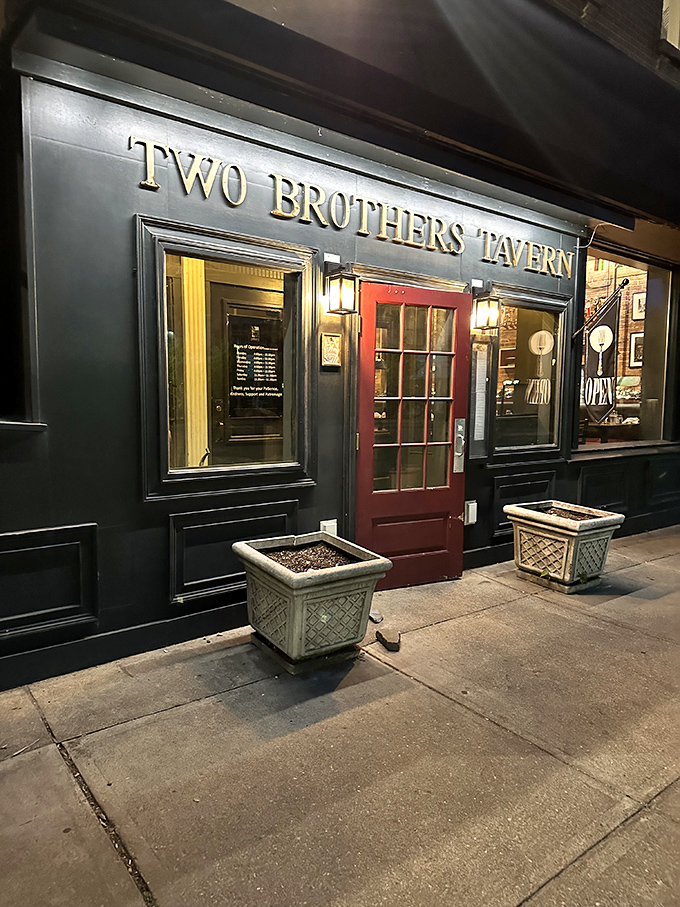 The entrance at night transforms into a beacon of culinary promise, drawing in hungry souls like moths to a delicious flame.