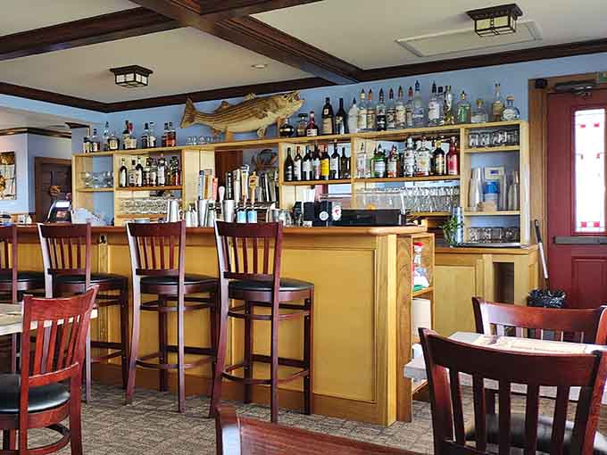 The bar area serves up drinks with a side of maritime charm, complete with fish decorations and bottles aplenty.